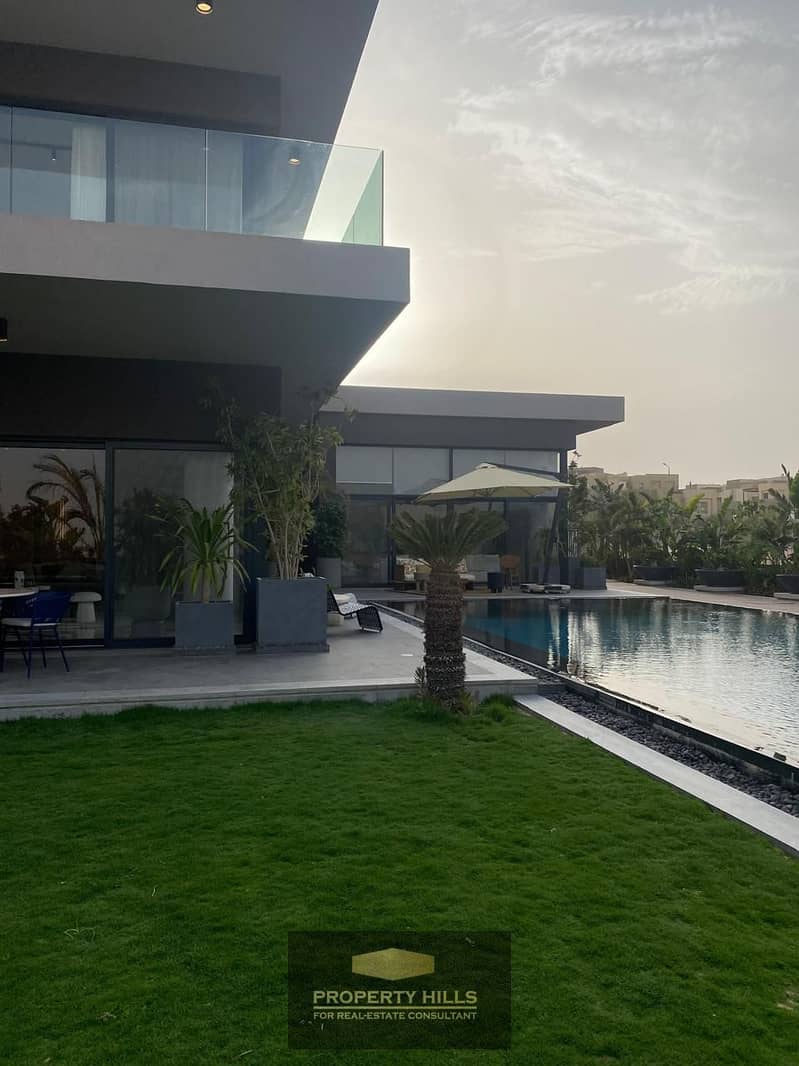 A standalone villa with a distinctive design and an open view of green ...